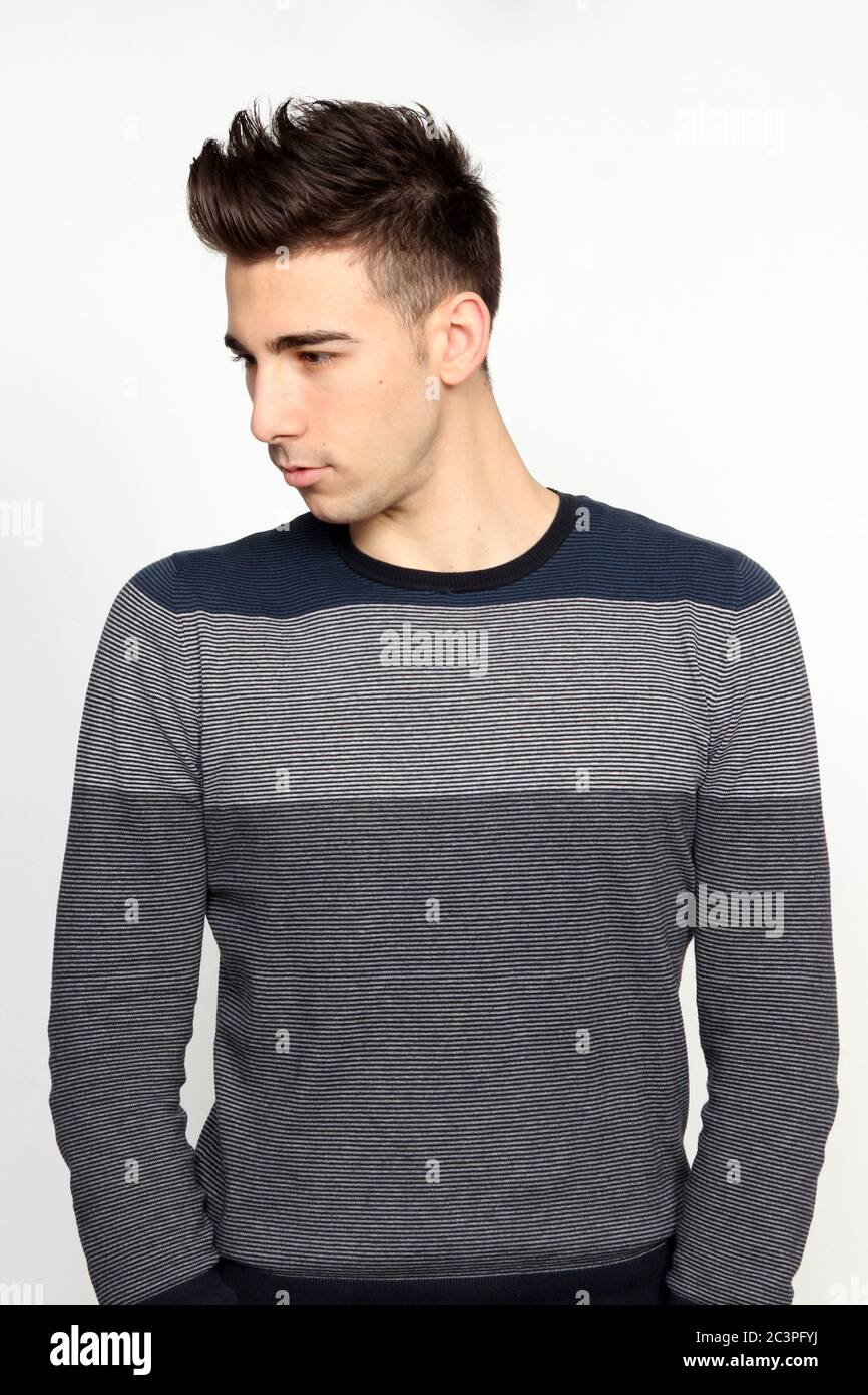 Attractive male model with short hair posing in studio on isolated ...