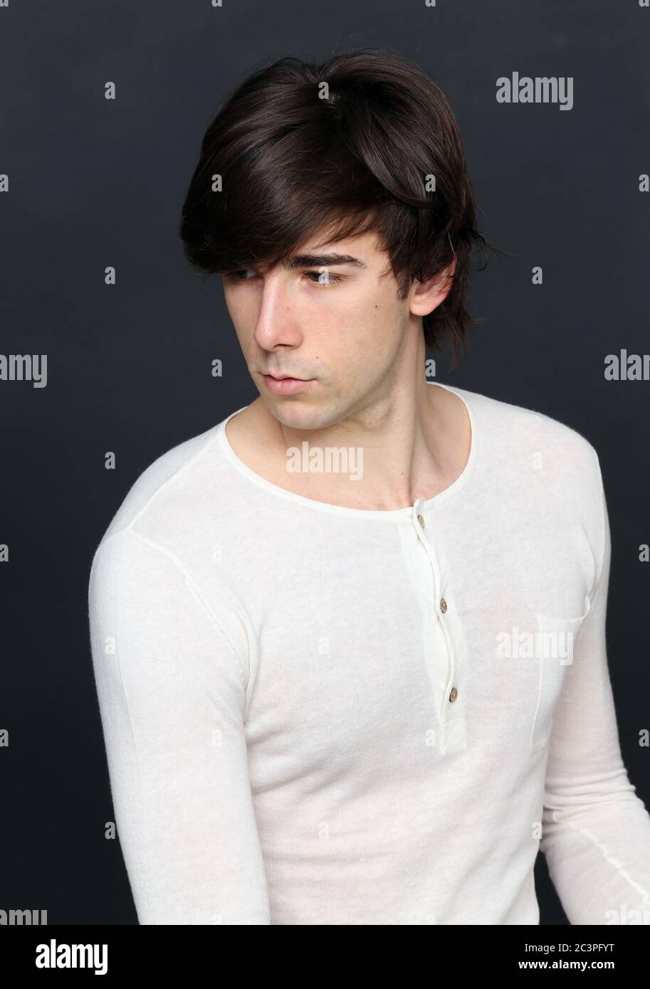 Attractive male model with short hair posing in studio on isolated ...