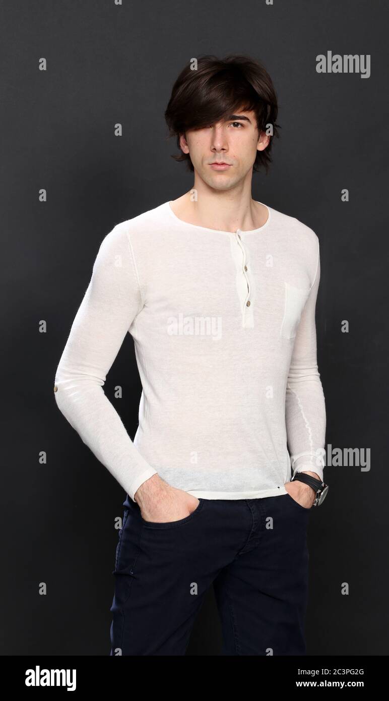 Attractive male model with short hair posing in studio on isolated ...