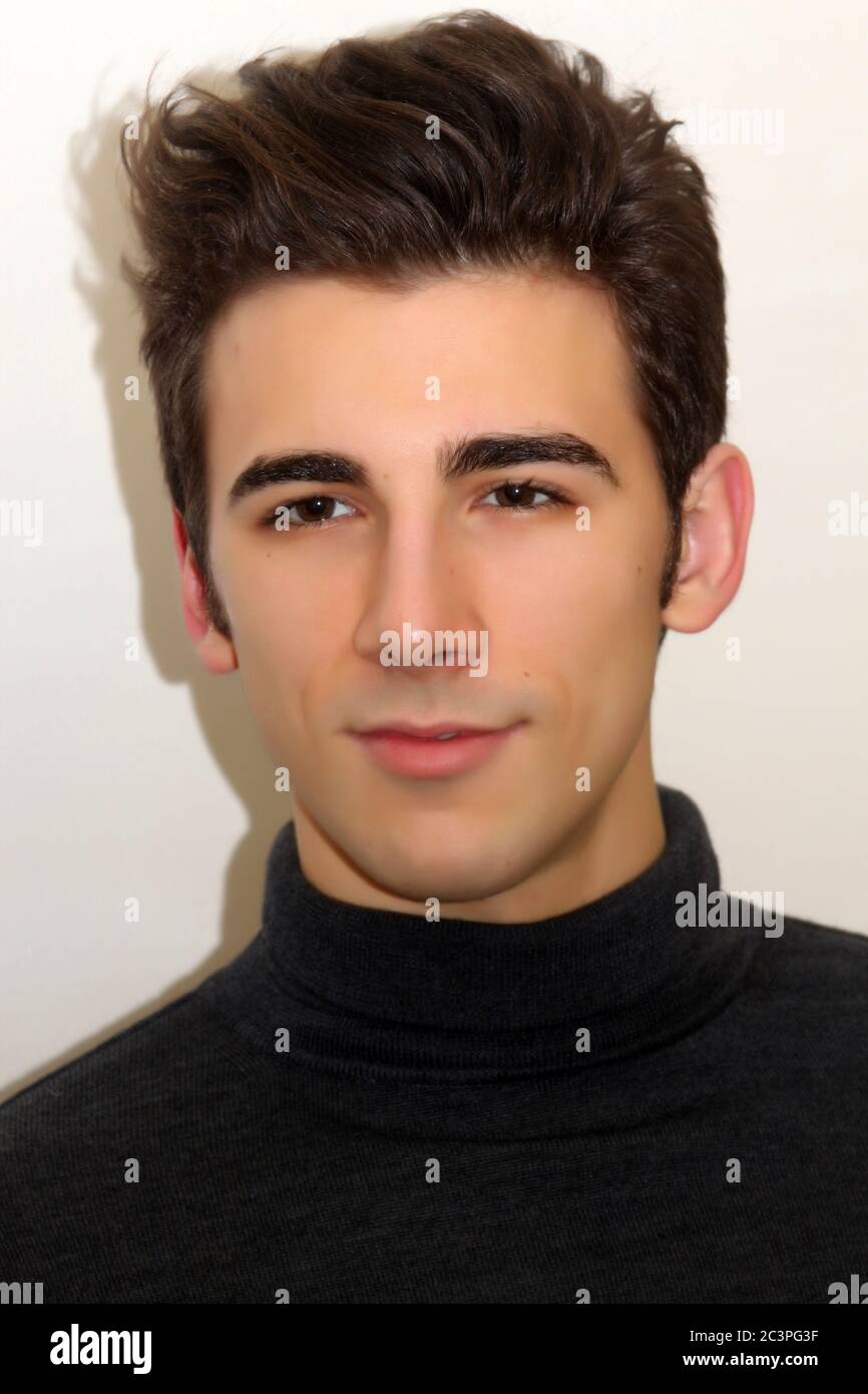 Attractive male model with short hair posing in studio on isolated ...