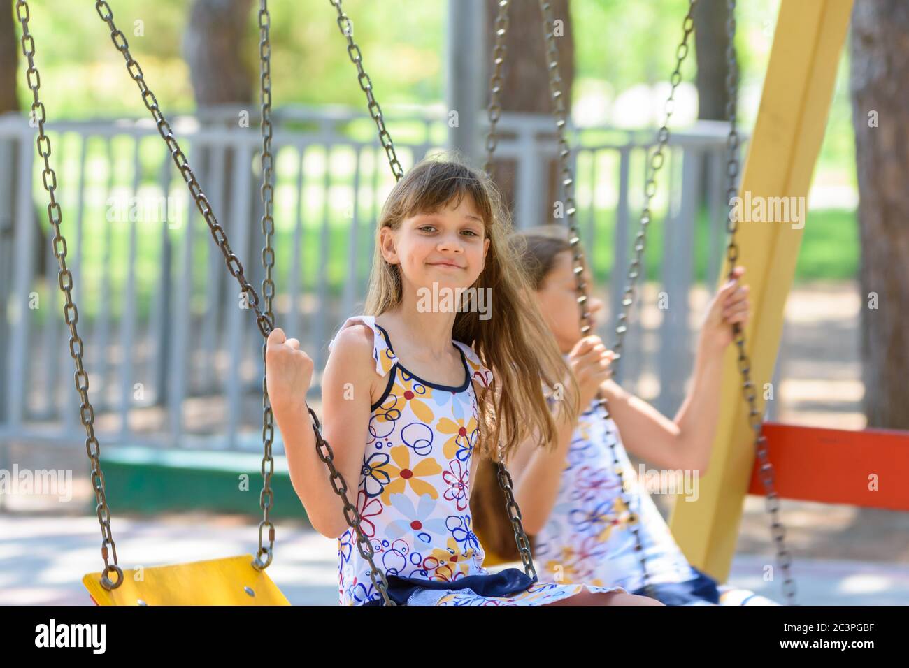 Two girls swing hi-res stock photography and images - Alamy