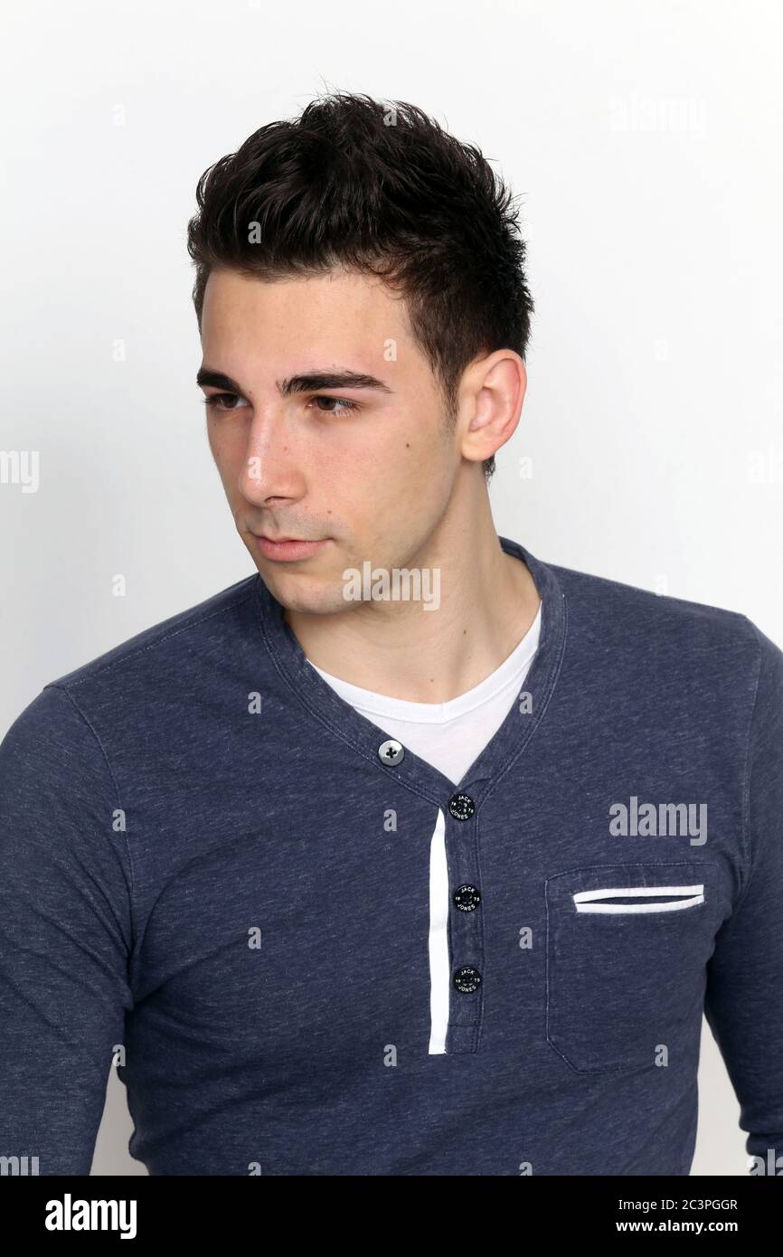 Attractive male model with short hair posing in studio on isolated ...