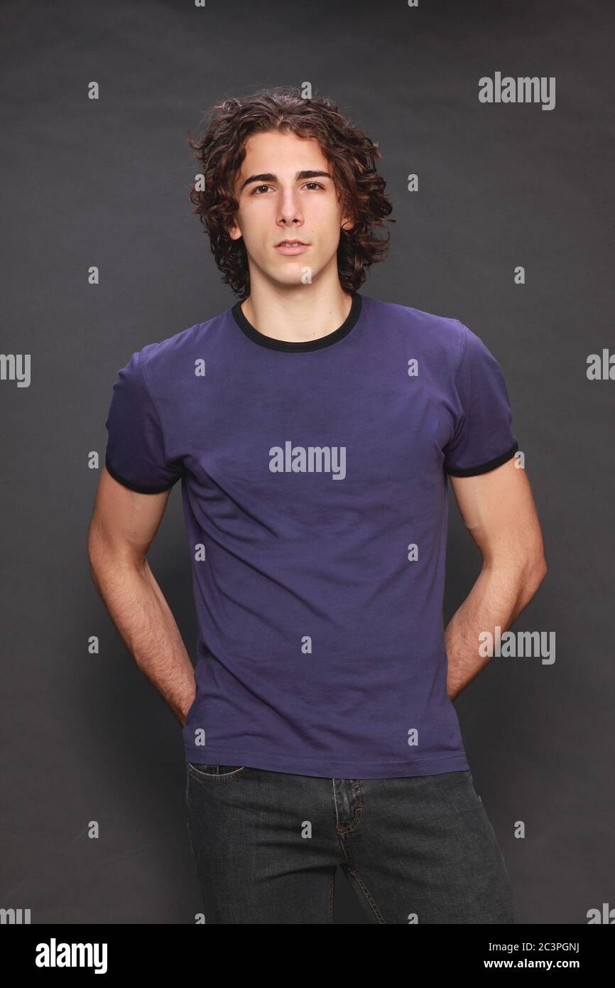 Attractive male model with short hair posing in studio on isolated ...