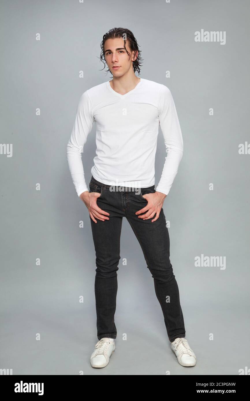 Attractive male model with short hair posing in studio on isolated ...