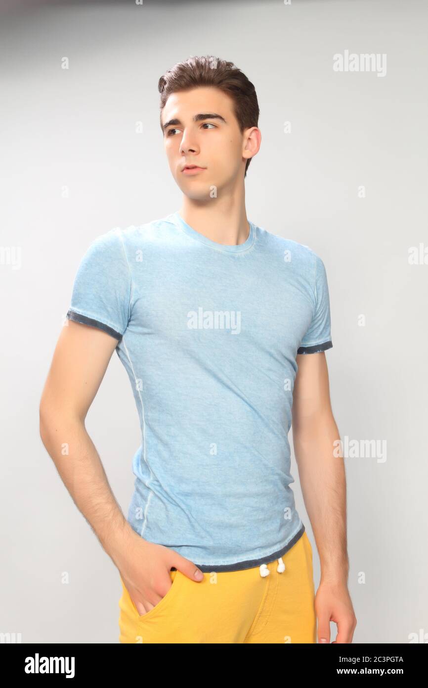 Attractive male model with short hair posing in studio on isolated ...