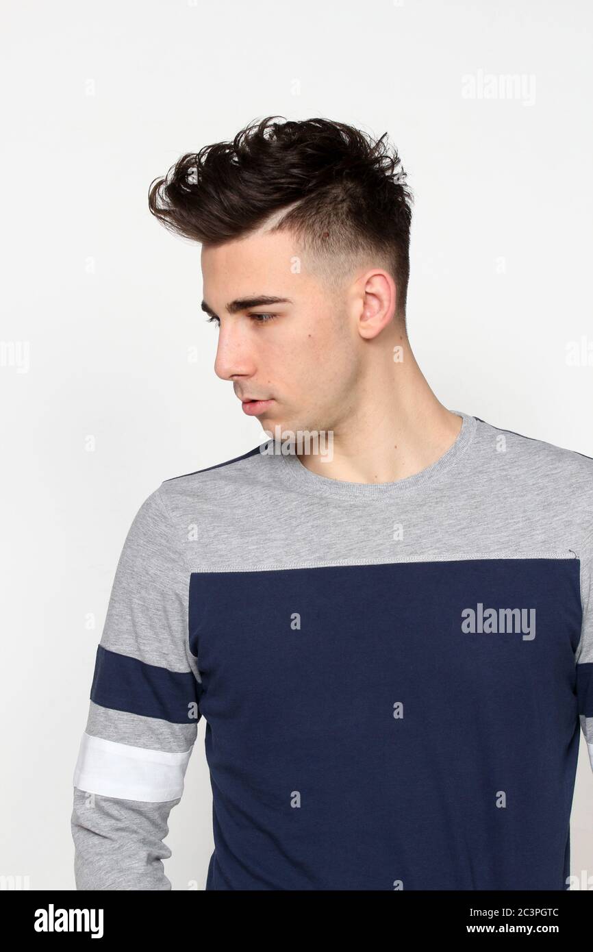 Attractive male model with short hair posing in studio on isolated ...