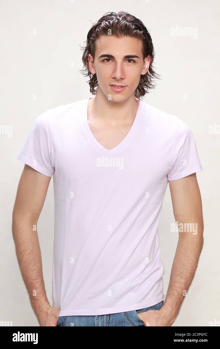 Attractive male model with short hair posing in studio on isolated ...