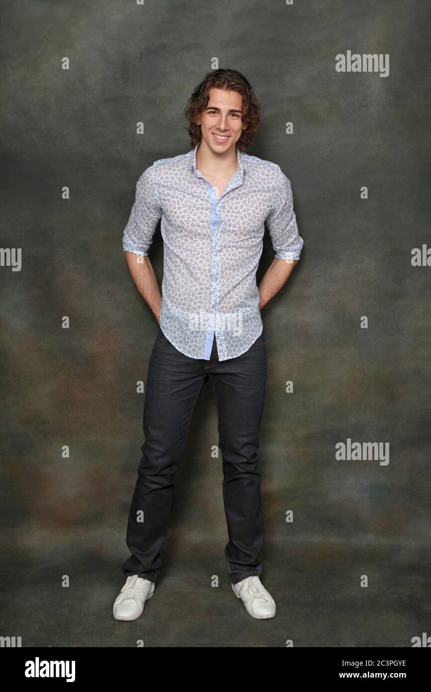 Attractive male model with short hair posing in studio on isolated ...