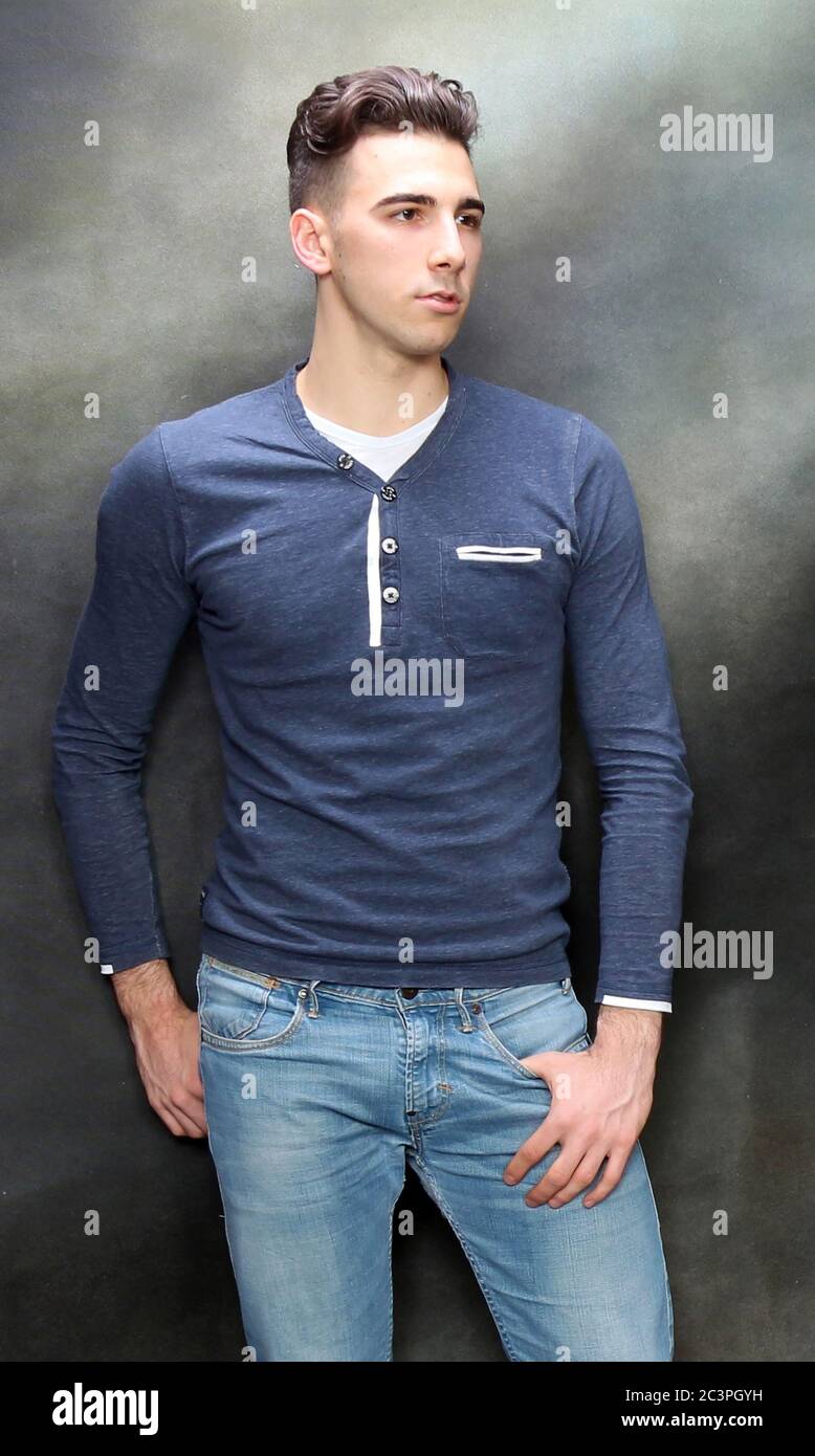 Attractive male model with short hair posing in studio on isolated ...