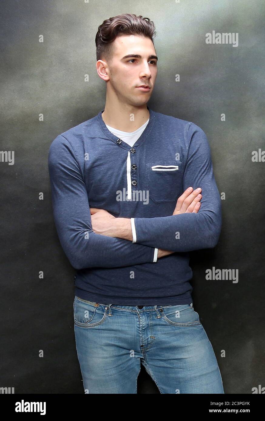 Attractive male model with short hair posing in studio on isolated ...