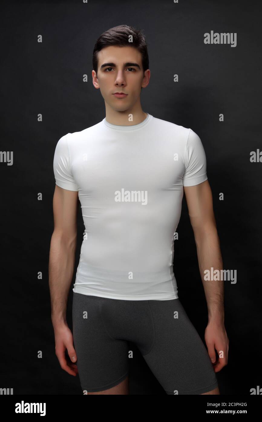 Attractive male model with short hair posing in studio on isolated ...