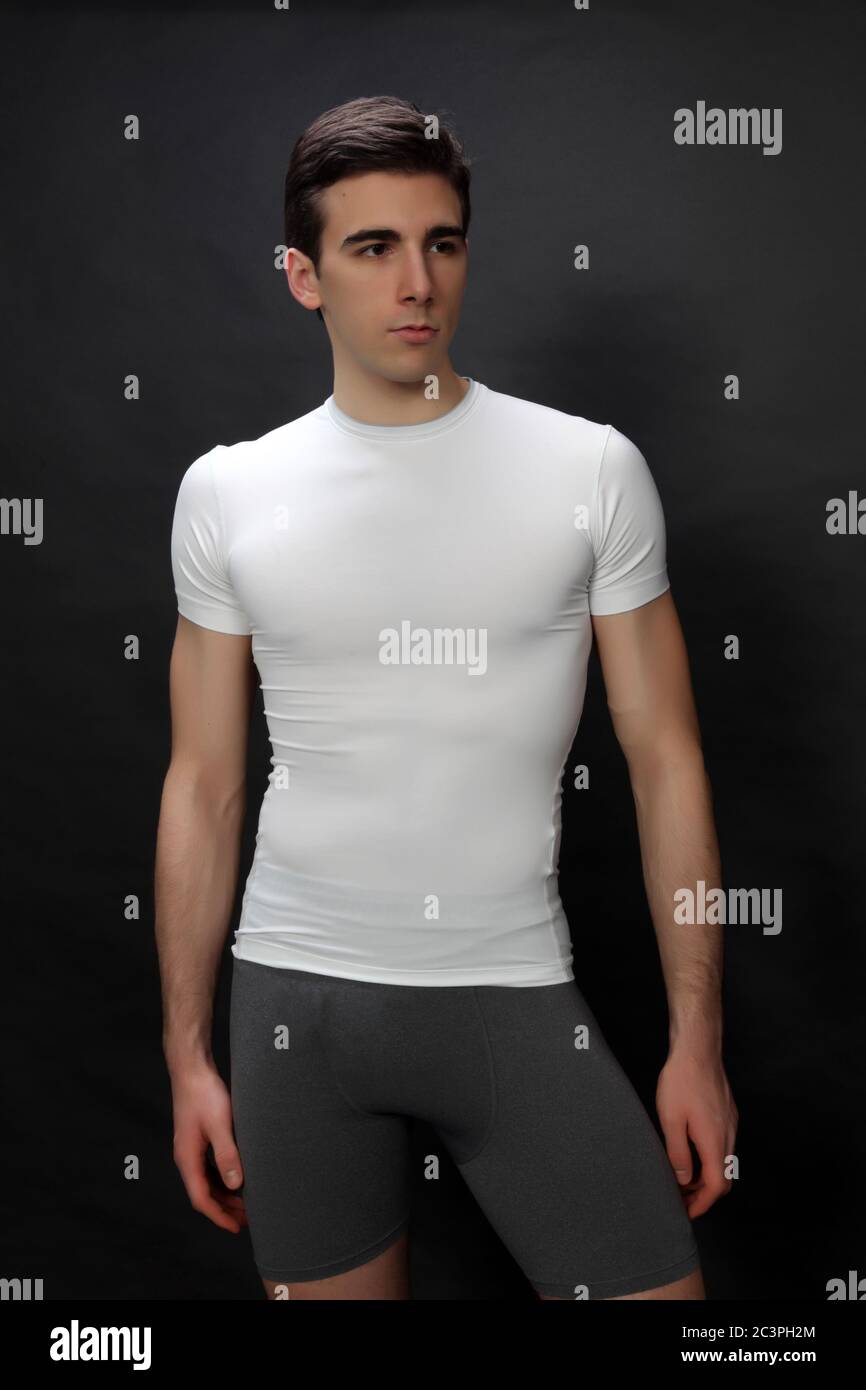 Attractive male model with short hair posing in studio on isolated ...