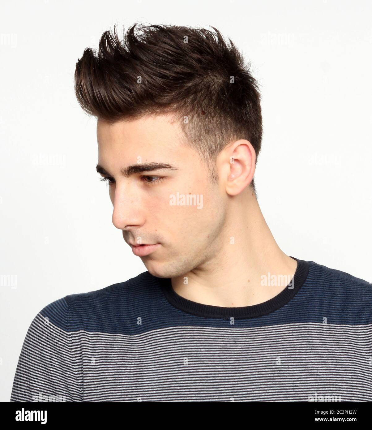 Attractive male model with short hair posing in studio on isolated ...