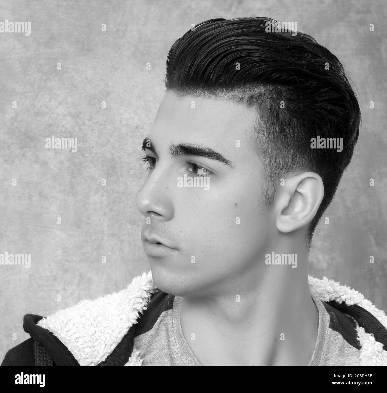 Attractive male model with short hair posing in studio on isolated ...