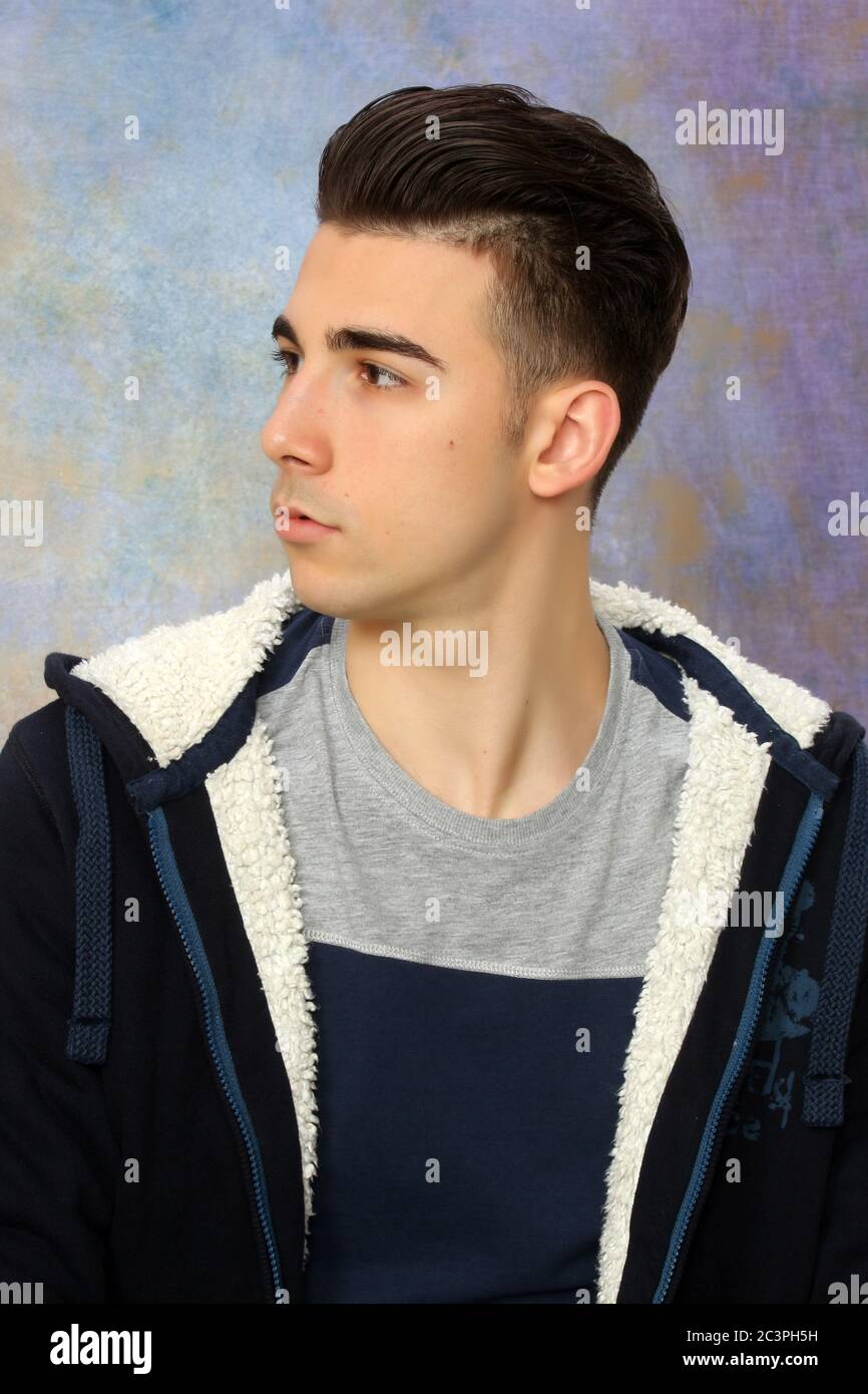 Attractive male model with short hair posing in studio on isolated ...