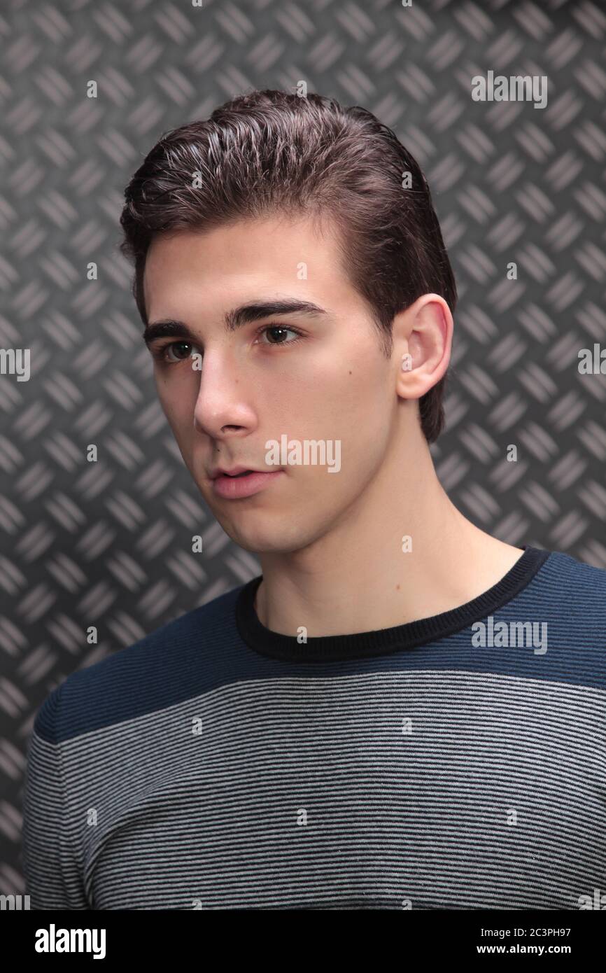Attractive male model with short hair posing in studio on isolated ...