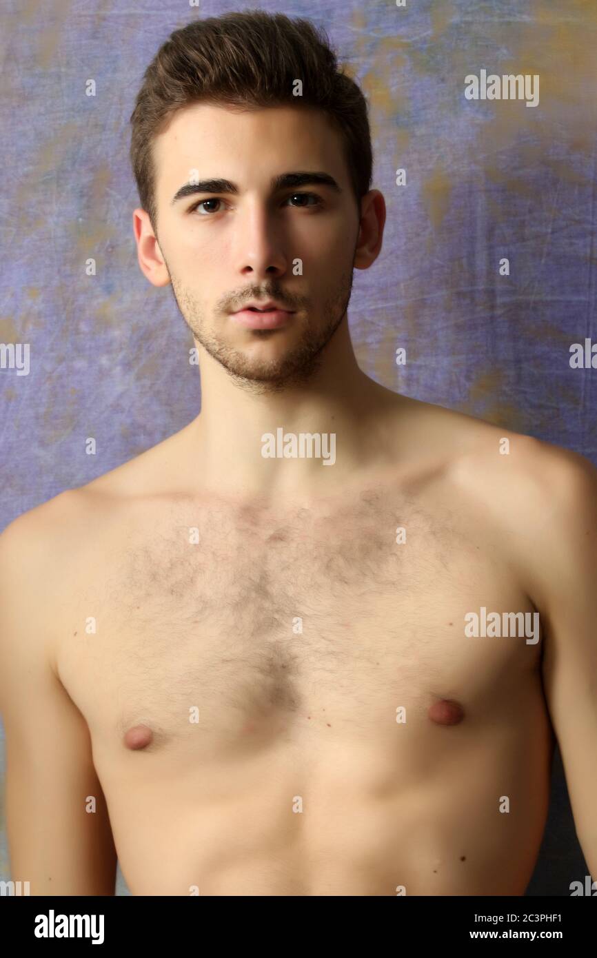 Attractive male model with short hair posing in studio on isolated ...