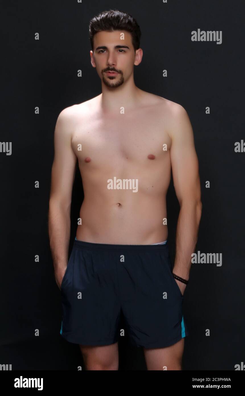Attractive male model with short hair posing in studio on isolated ...