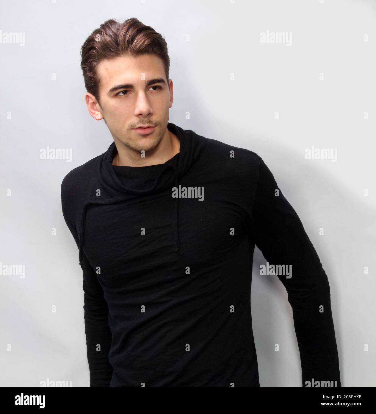 Attractive male model with short hair posing in studio on isolated ...