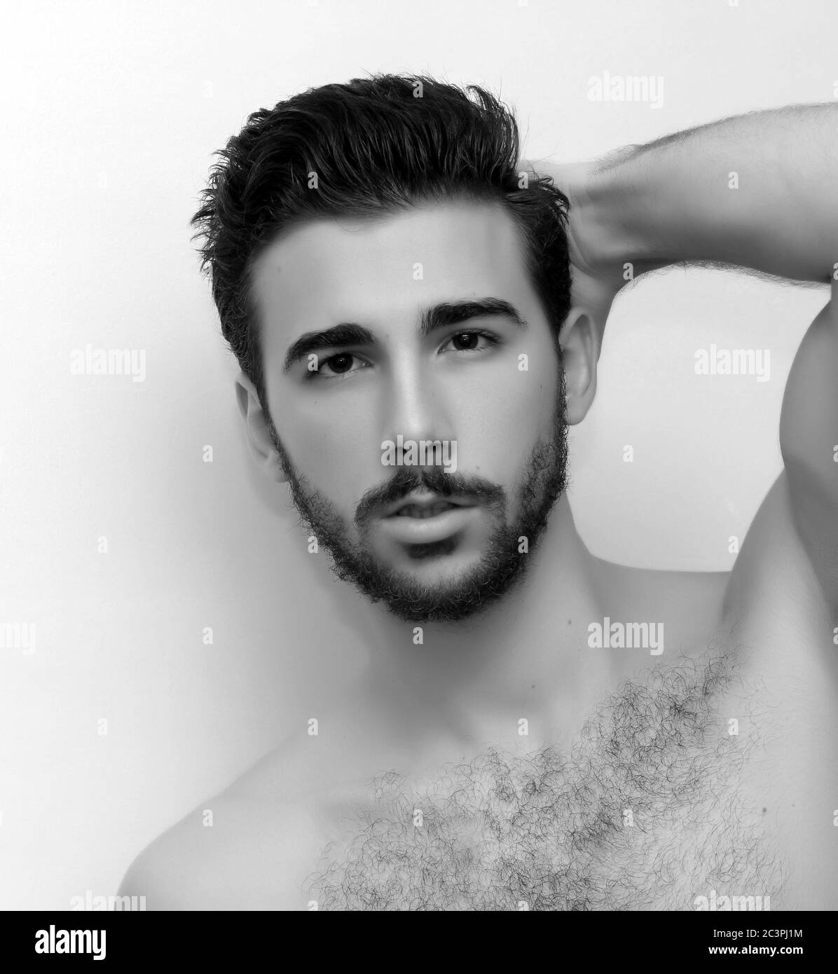 Attractive male model with short hair posing in studio on isolated ...