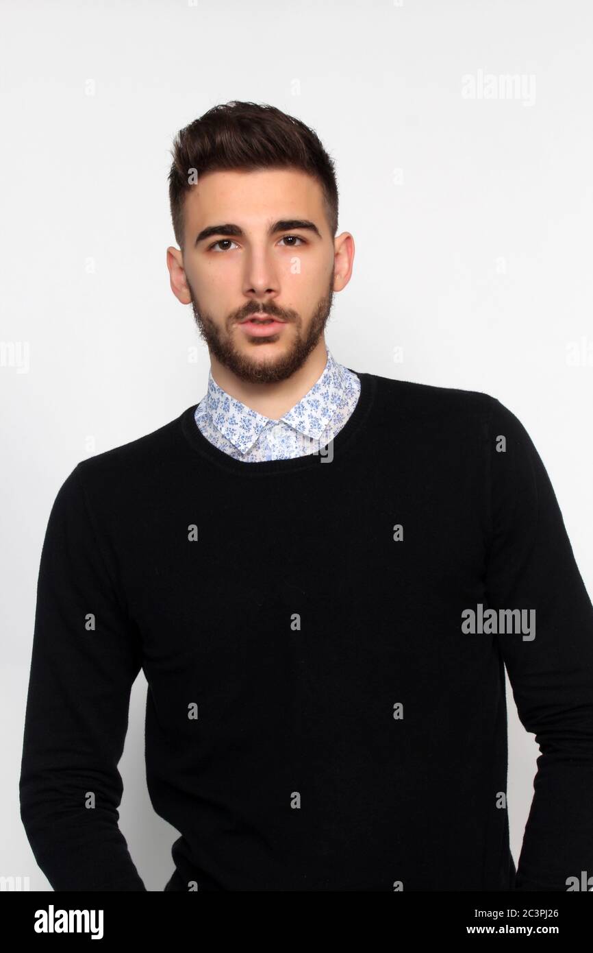 Attractive male model with short hair posing in studio on isolated ...