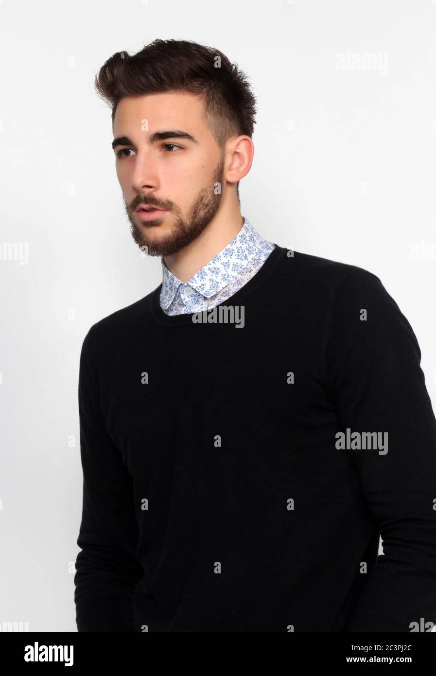 Attractive male model with short hair posing in studio on isolated ...