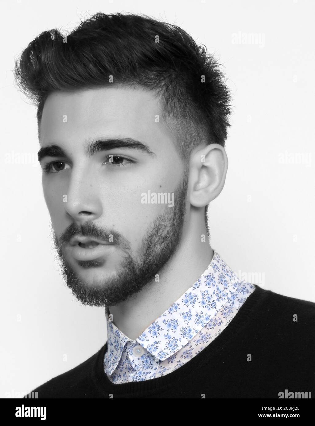 Attractive male model with short hair posing in studio on isolated ...
