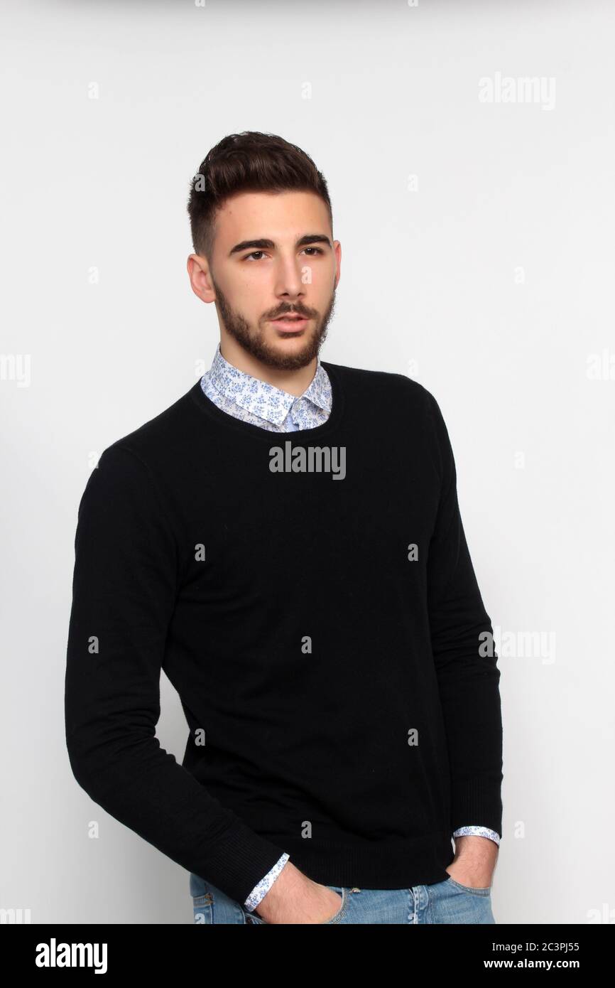 Attractive male model with short hair posing in studio on isolated ...