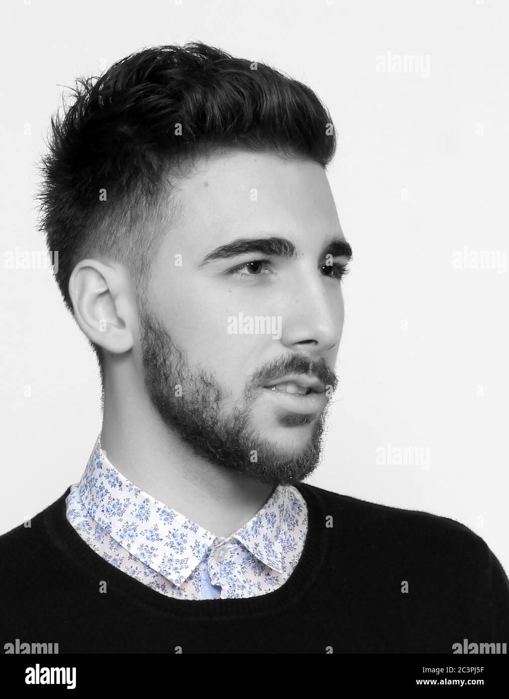 Attractive male model with short hair posing in studio on isolated ...