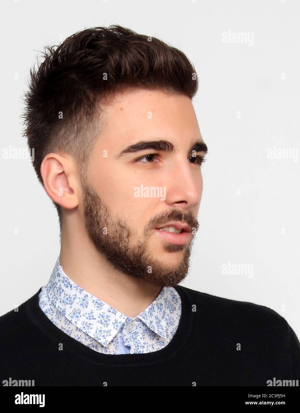 Attractive male model with short hair posing in studio on isolated ...