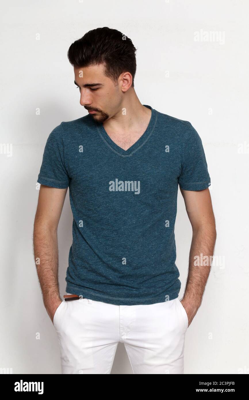 Attractive male model with short hair posing in studio on isolated ...