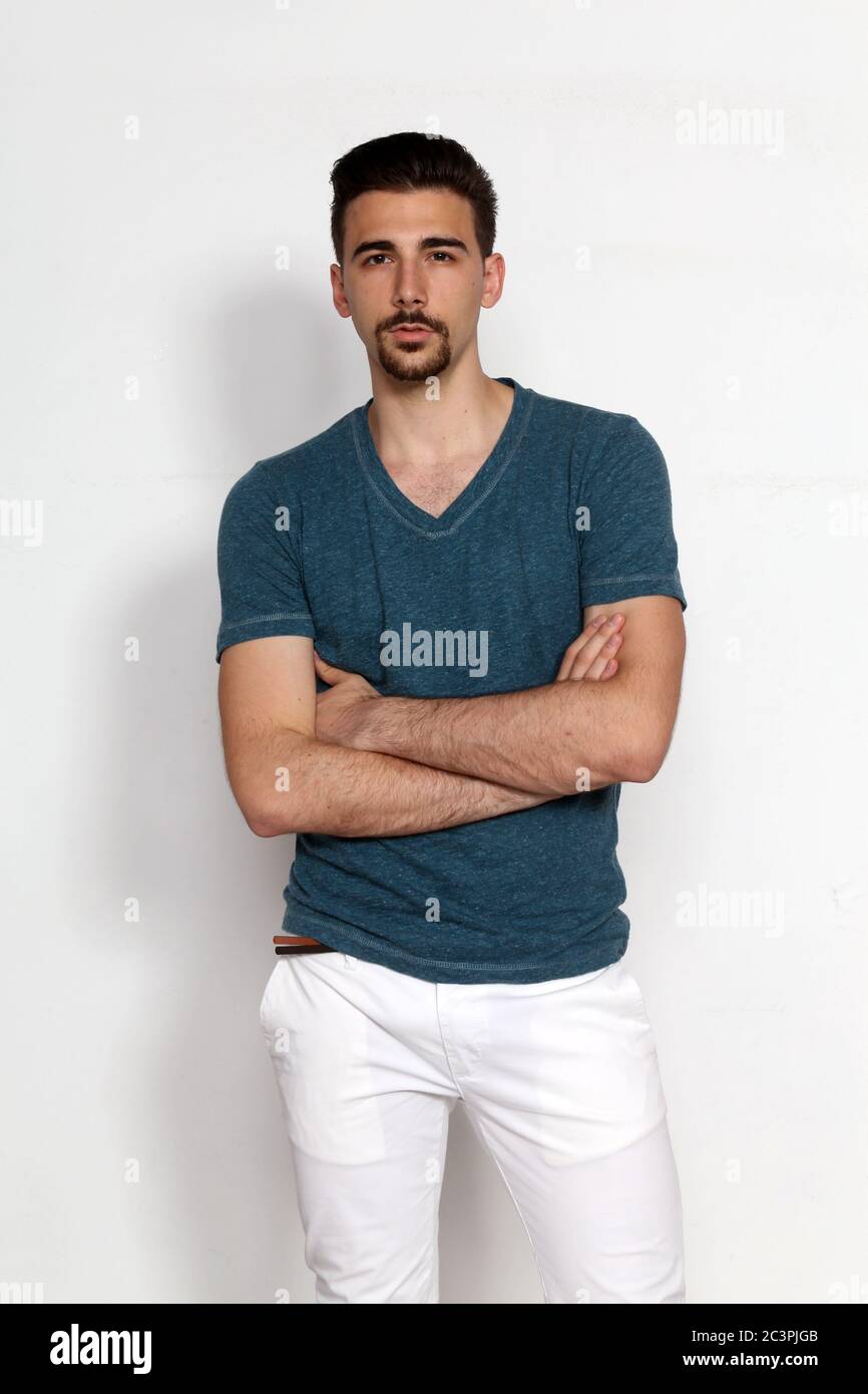 Attractive male model with short hair posing in studio on isolated ...