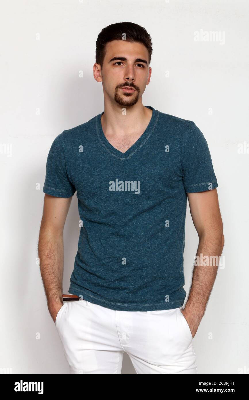 Attractive male model with short hair posing in studio on isolated ...
