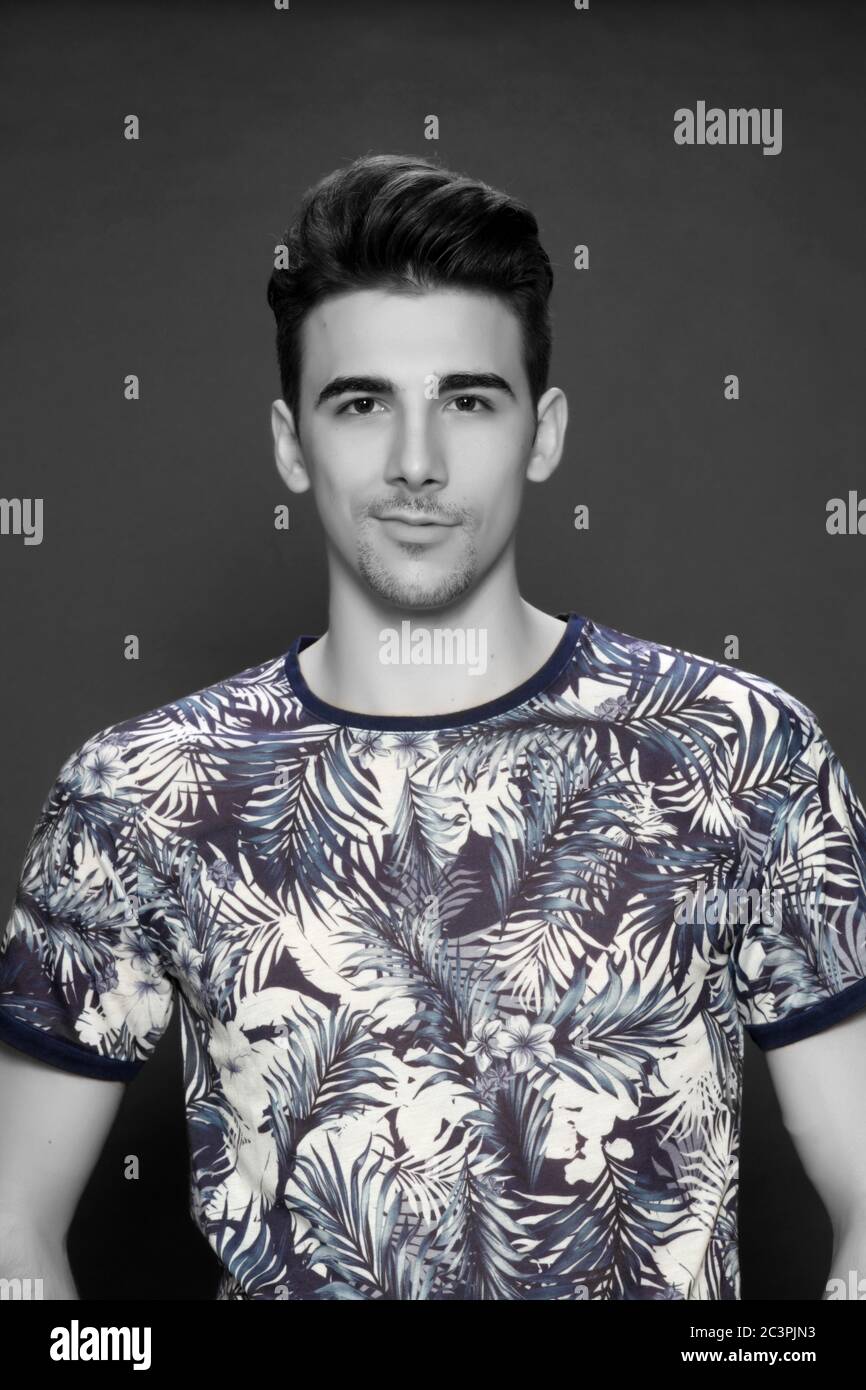 Attractive male model with short hair posing in studio on isolated ...