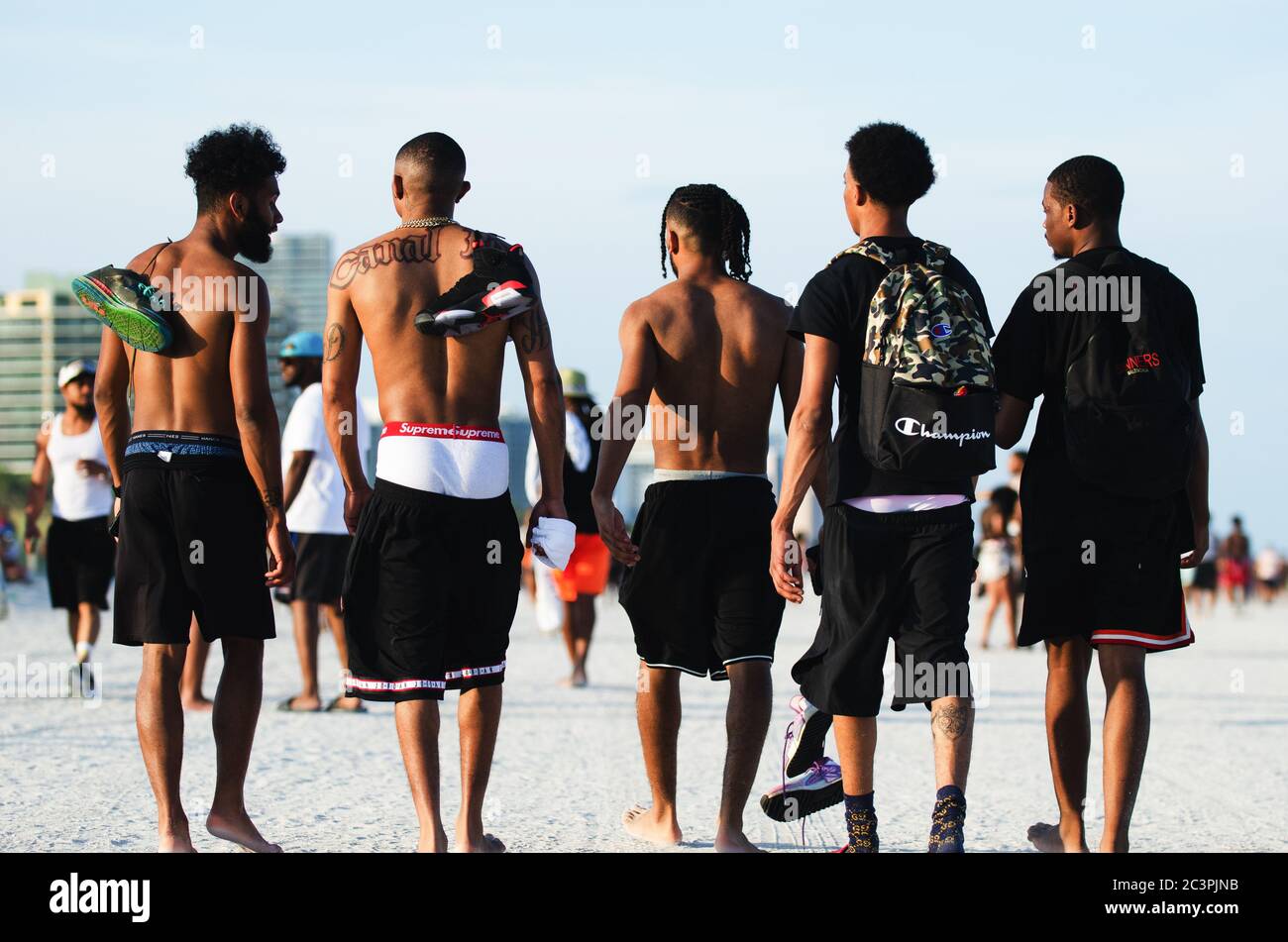 MIAMI - MARCH 16, 2019: A group of young men walk from a gathering of ...
