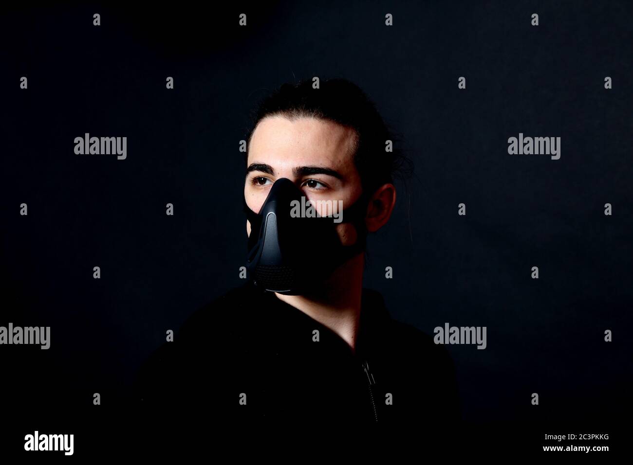 Young male model with mask posing in studio. Fantasy, Halloween, Sci-Fi ...