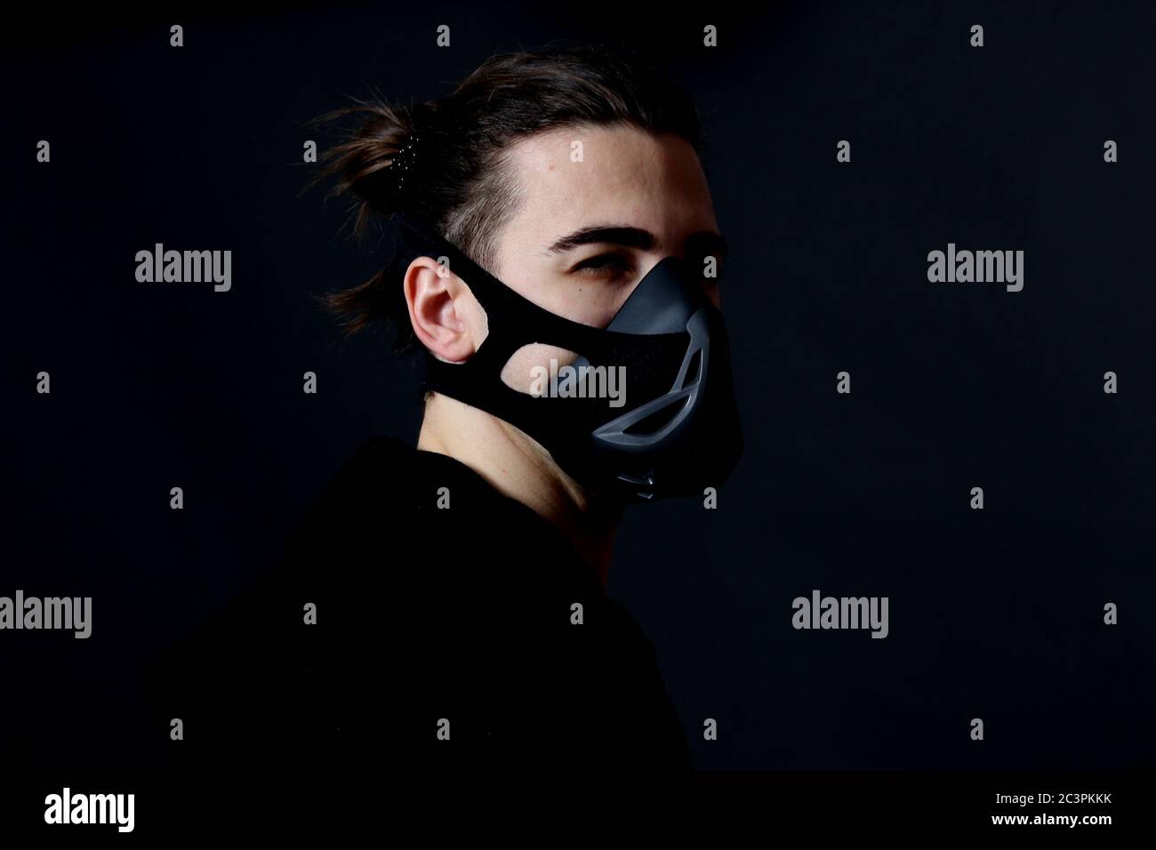 Young male model with mask posing in studio. Fantasy, Halloween, Sci-Fi ...