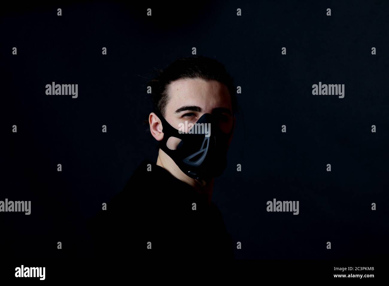 Young male model with mask posing in studio. Fantasy, Halloween, Sci-Fi ...
