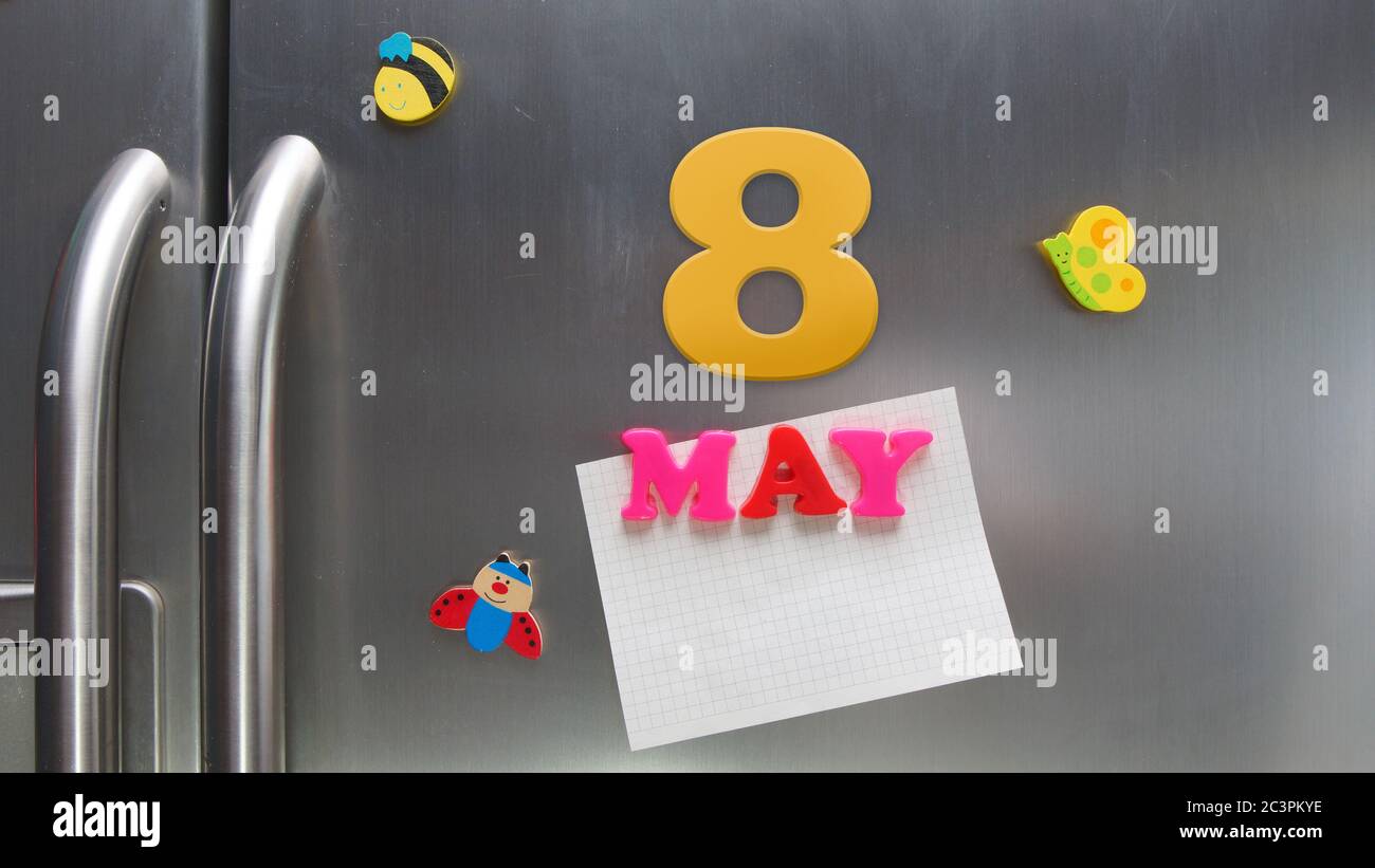 May 8 calendar date made with plastic magnetic letters holding a note ...