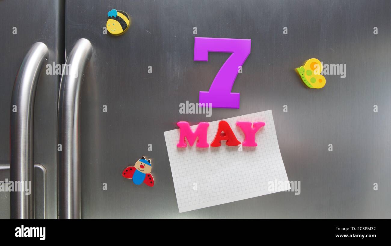 May 7 calendar date made with plastic magnetic letters holding a note ...
