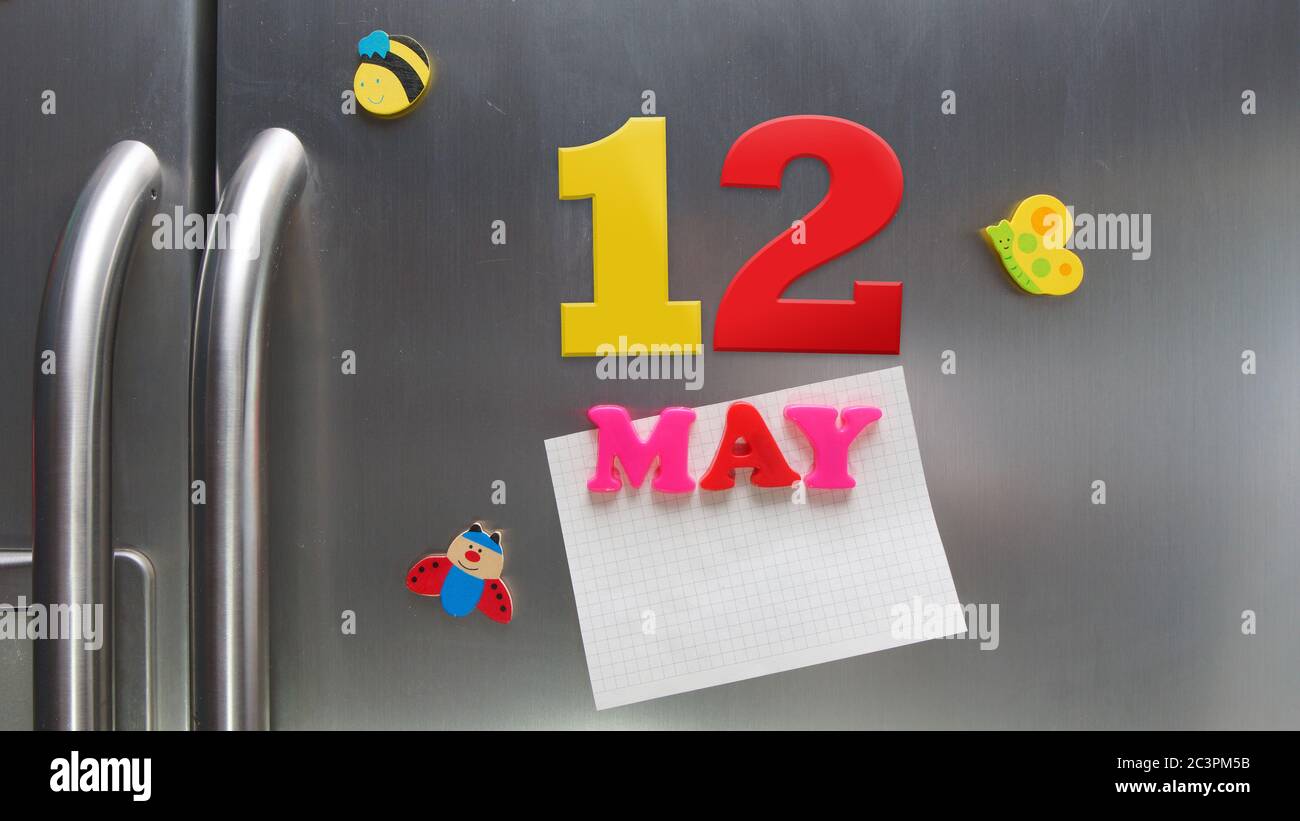 May 12 calendar date made with plastic magnetic letters holding a note ...