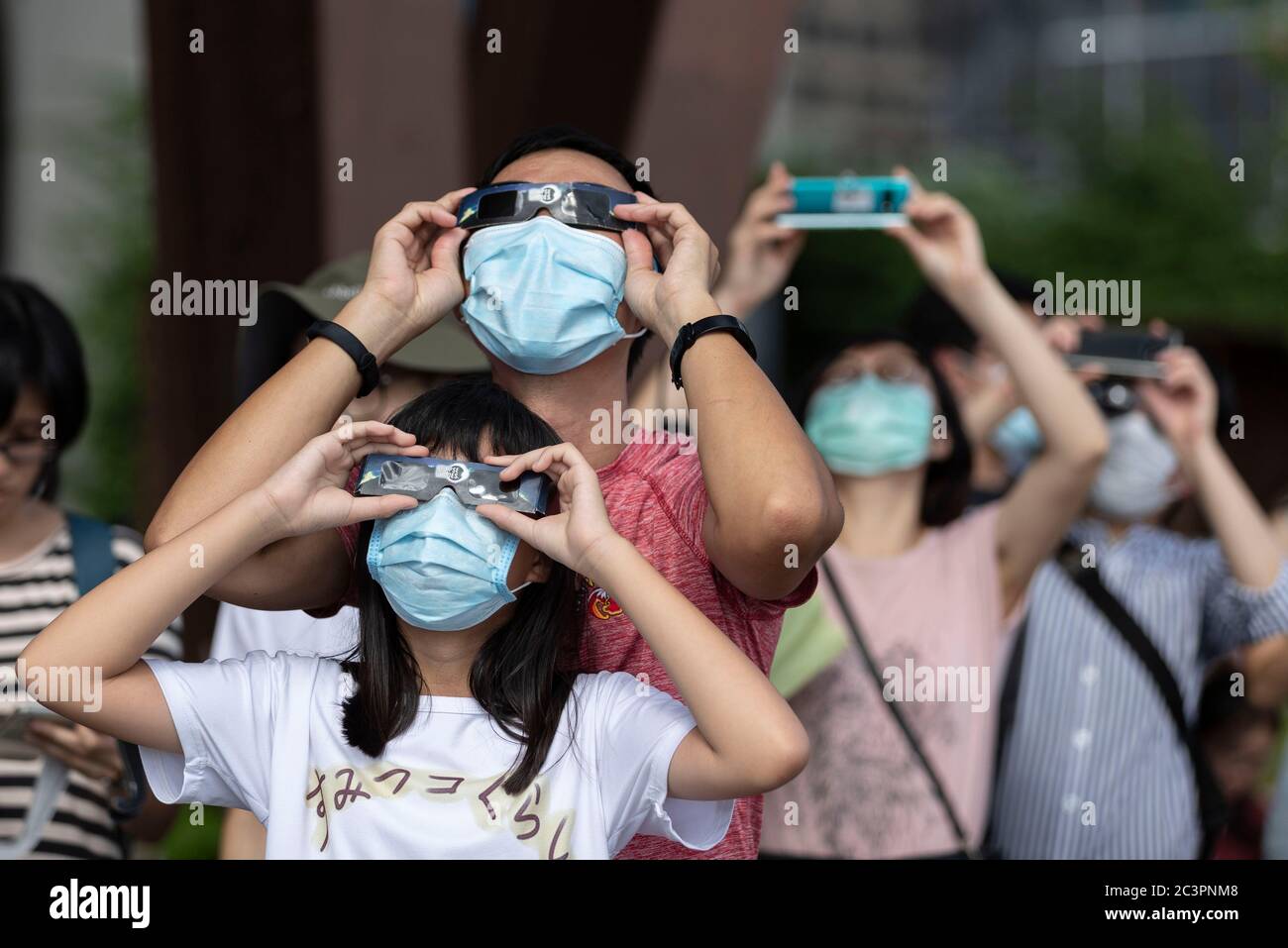 Hong Kong, China. 21st June, 2020. People watches an annular partial ...