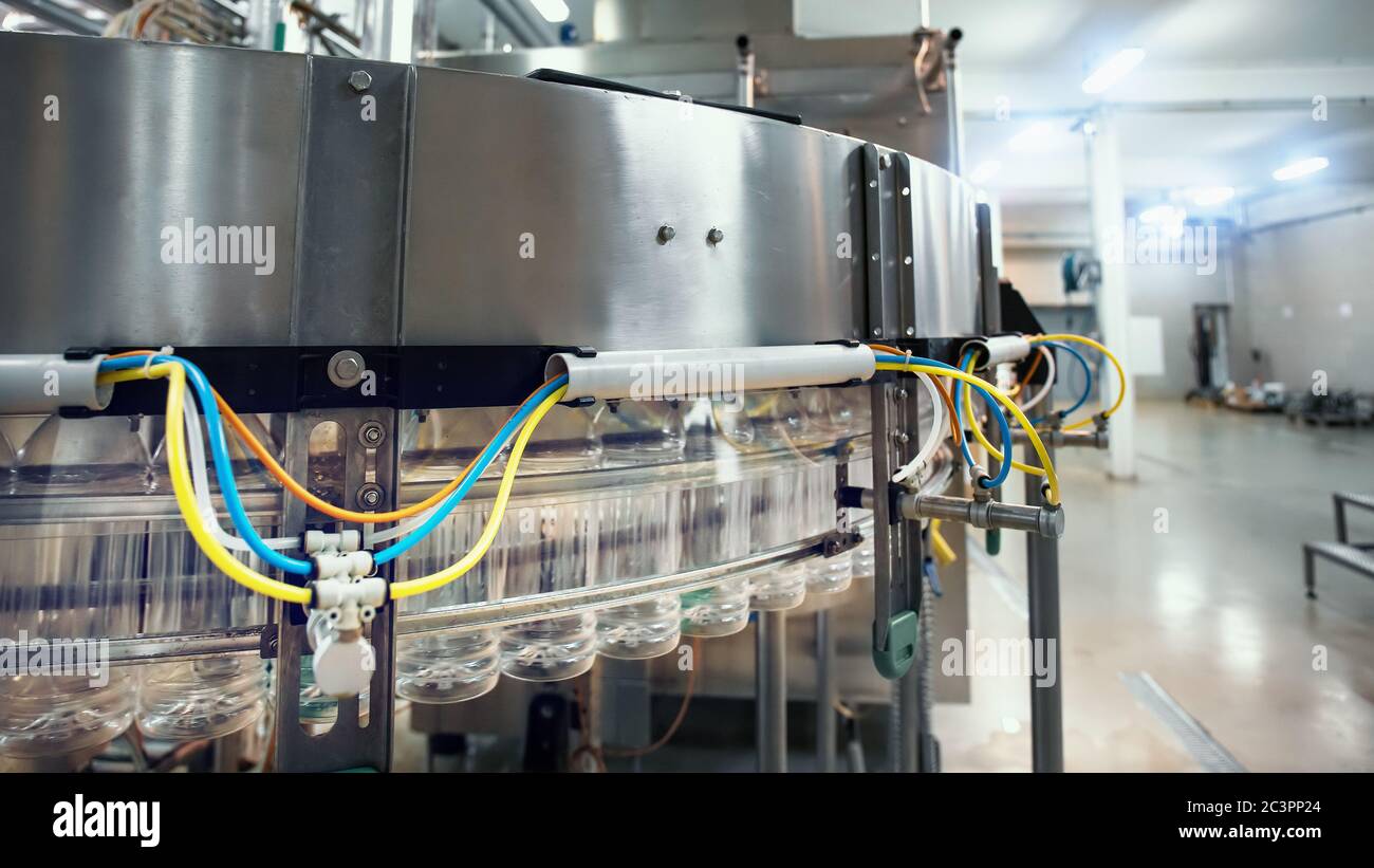 Production line of plastic bottles, conveyor line in beverage factory ...