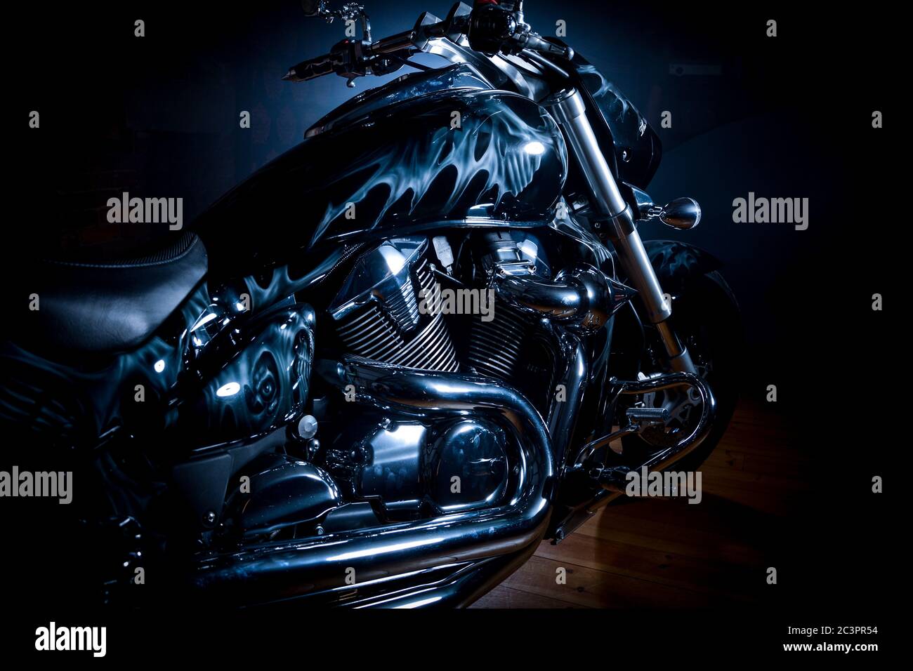 Shot of a black motorcycle taken indoors with a dark background Stock ...