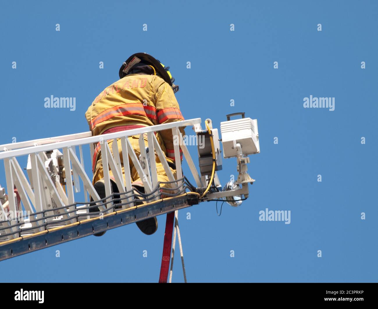 One firefighter in turnout gear ascending a ladder truck Oakland Fire ...