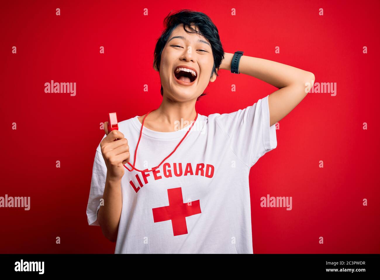 Young beautiful asian lifeguard girl wearing t-shirt with red cross ...