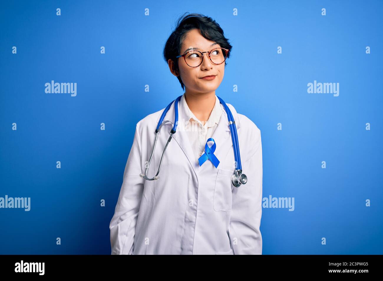 Young beautiful asian doctor girl wearing stethoscope and coat with ...