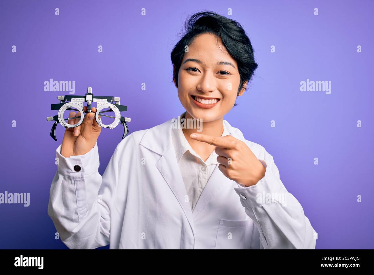 Beautiful asian optical girl wearing coat holding optometry glasses ...