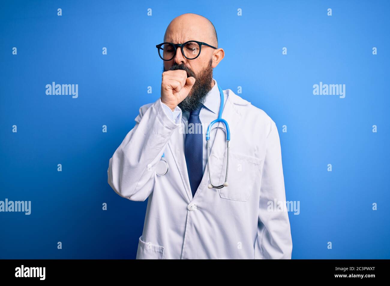 Handsome bald doctor man with beard wearing glasses and stethoscope ...