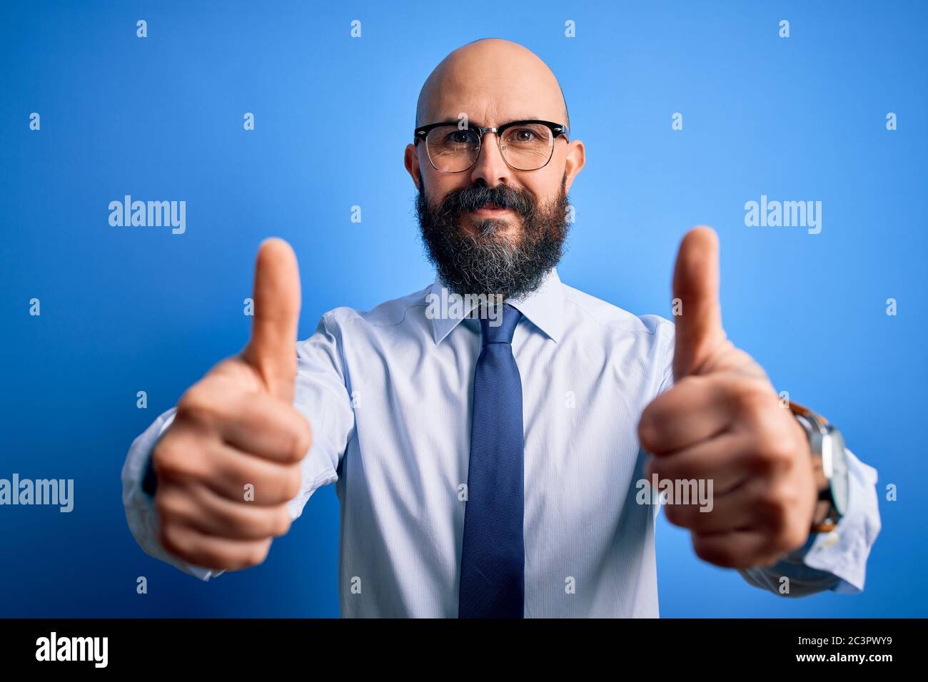 Handsome business bald man with beard wearing elegant tie and glasses ...